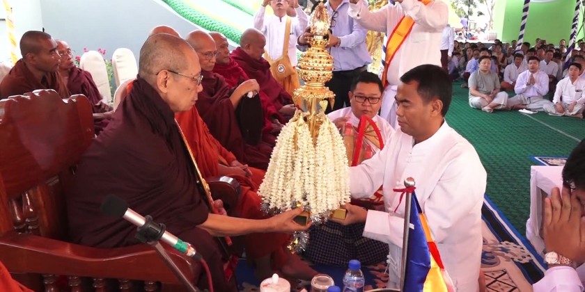 Religious Ceremony: Golden umbrella, vane and diamond bud hoisted atop ...
