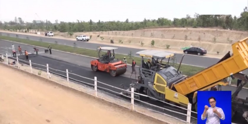 Inspection of road construction: Paving asphalt on road section ...