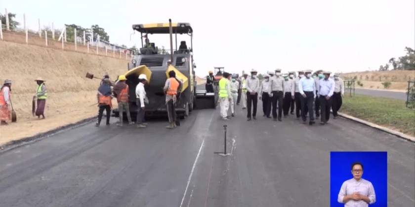 Inspection of road construction: Paving asphalt on road section ...